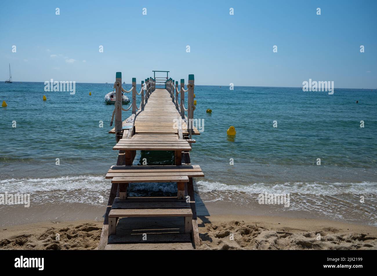 Wooden pier for guests of yachts on legendary Pampelonne beach near ...