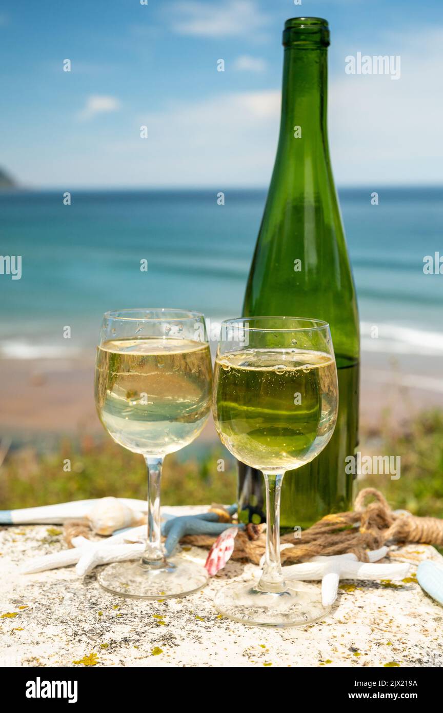 Tasting of txakoli or chacolí slightly sparkling very dry white wine ...