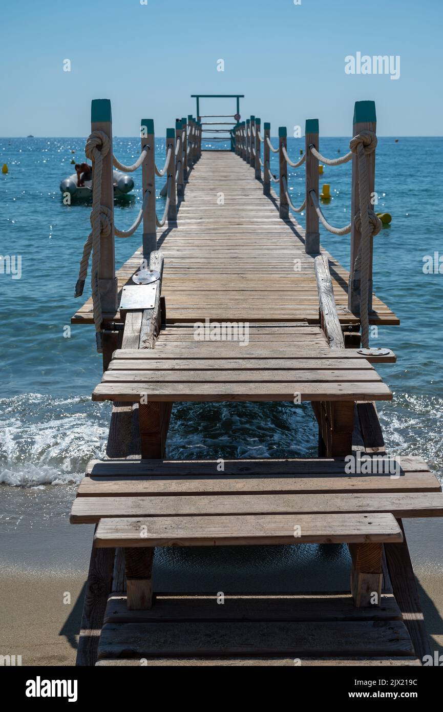 Wooden pier for guests of yachts on legendary Pampelonne beach near ...