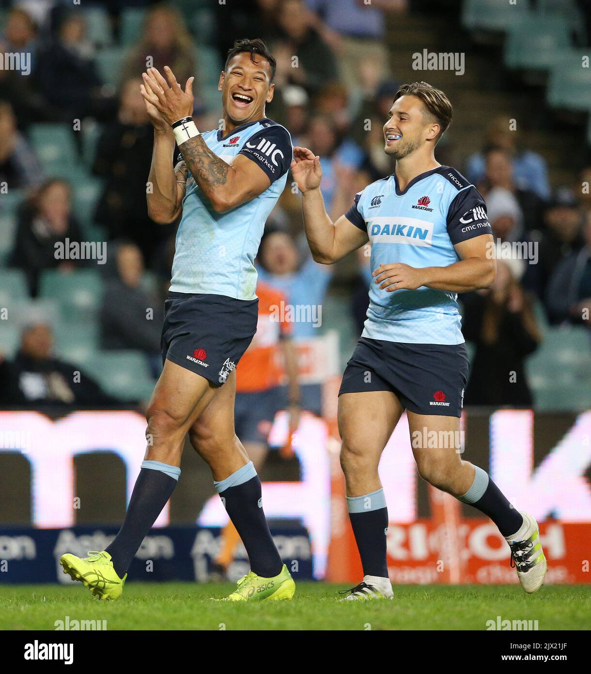 Israel Folau(left) of the Waratahs celebrates after scoring his second ...