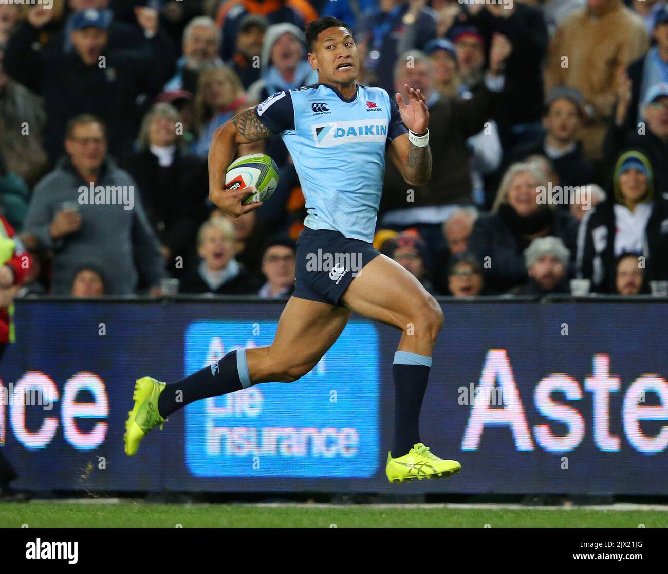 Israel Folau runs with the ball to score a try during the Round 14 ...