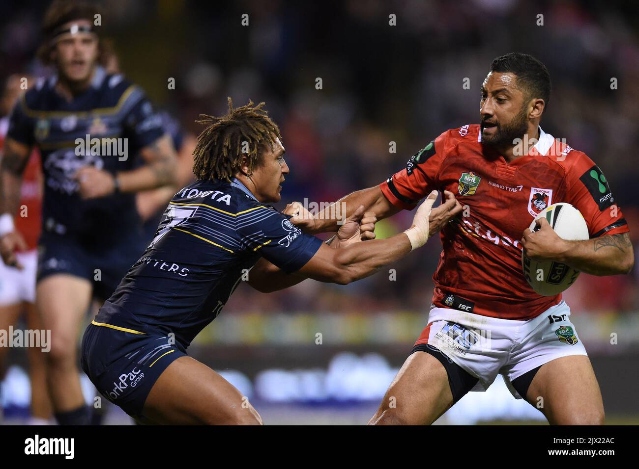 Benji Marshall of the Dragons fends off a tackle by Ray Thompson of the ...