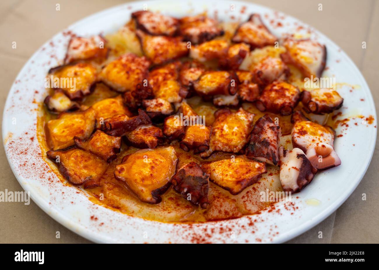 Tasty seafood, grilled octopus galician style with red pimento paprika ...