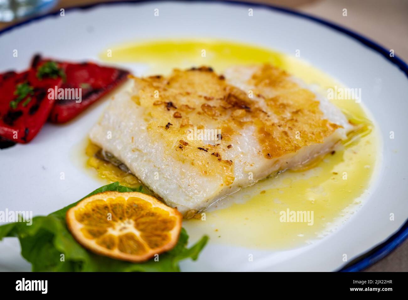 Grilled fillet of white sea bass served in fish restaurant in San ...