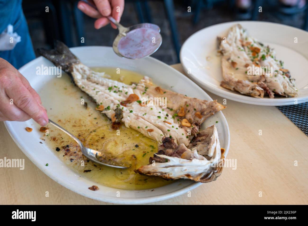 Serving in restaurant of fresh grilled with garlic and olive oil on old ...