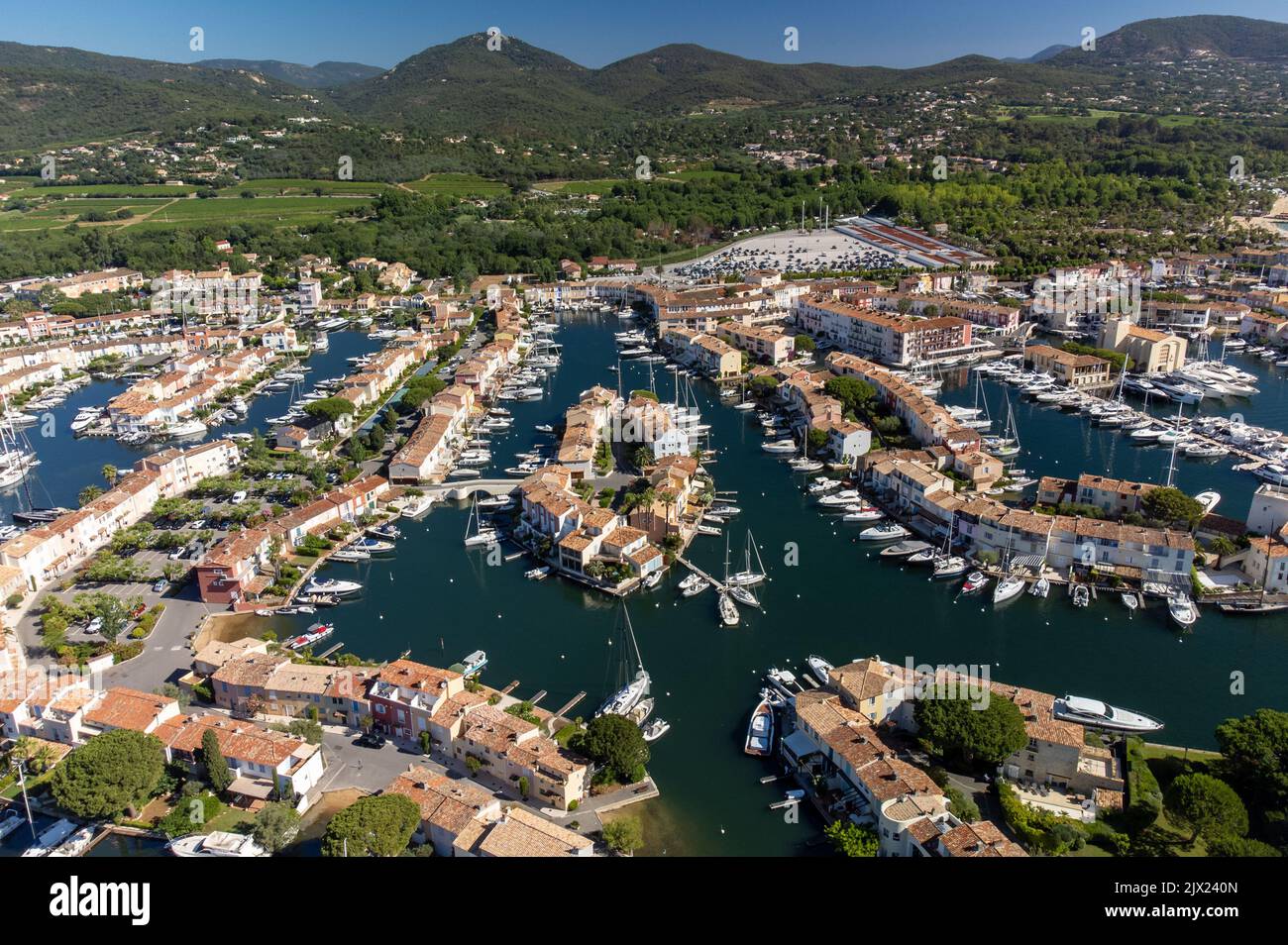 Aerial view on blue water of Gulf of Saint-Tropez, sail boats, houses ...