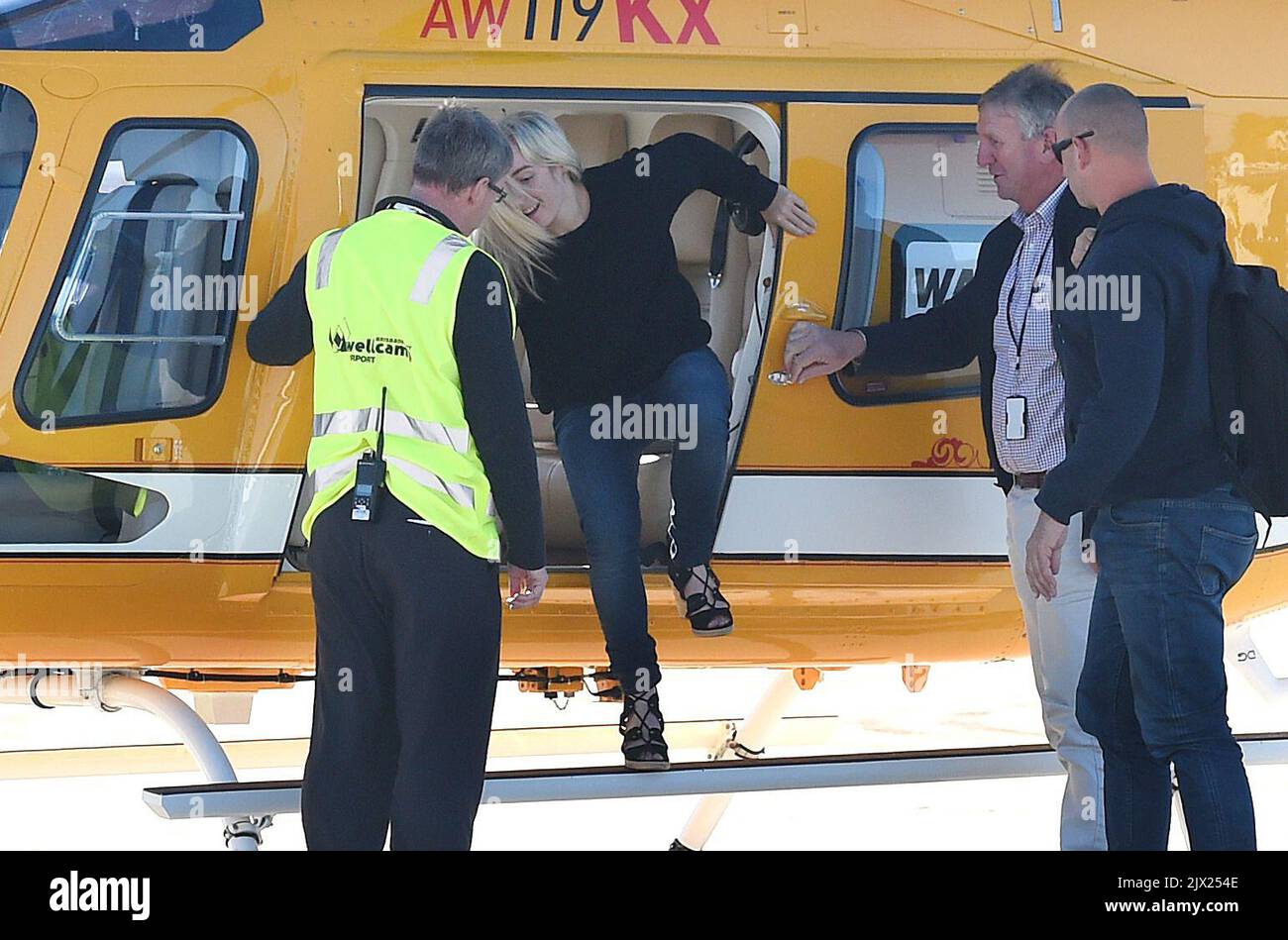 Alyssa Azar climbs out of a helicopter, chartered by businessman Denis ...