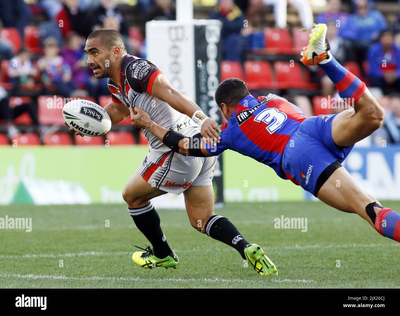 Thomas Leuluai of the Warriors is tackled by Sione Mata'utia of the knights during the Round 14 ...