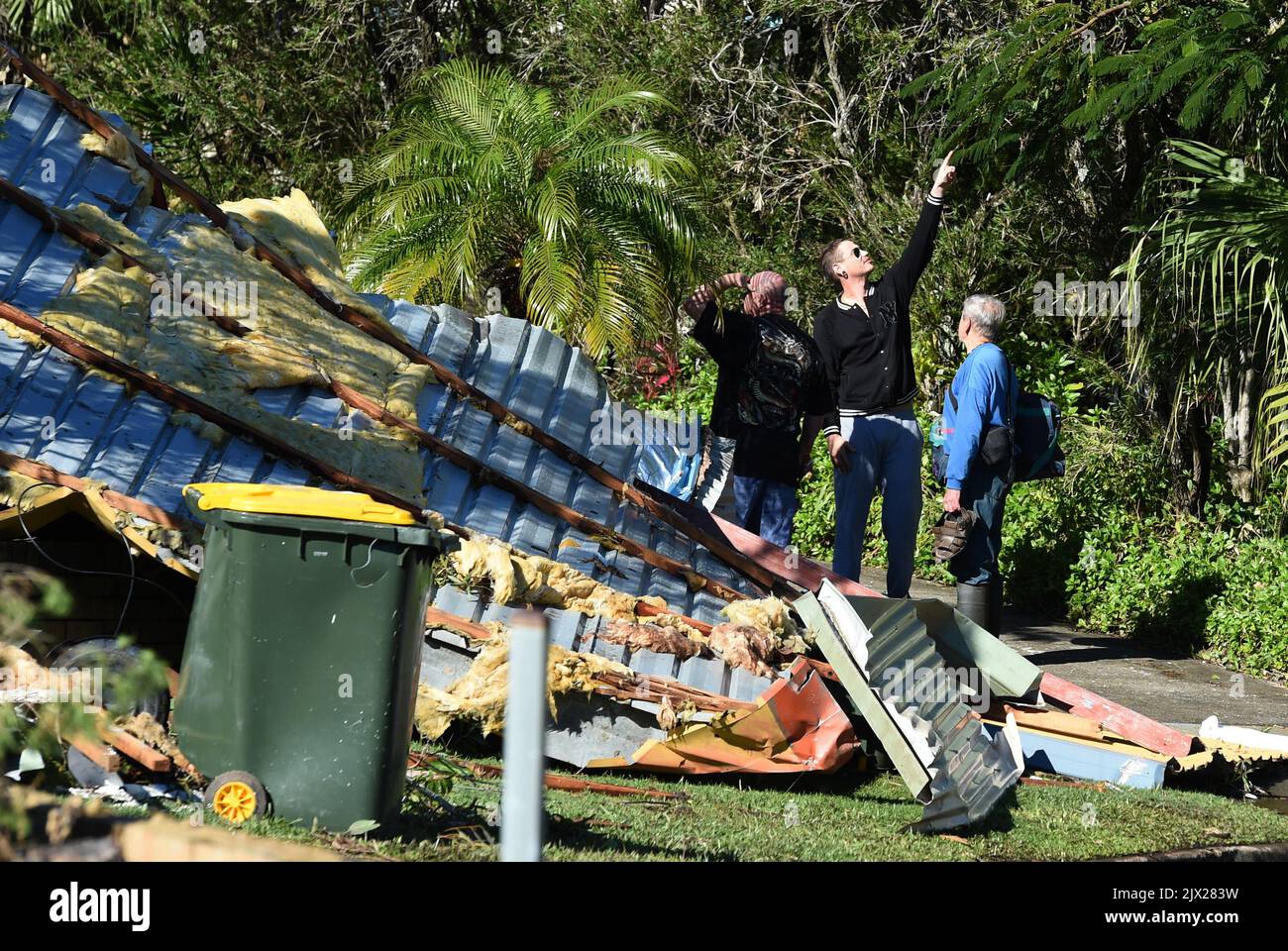 Residents survey the damage after a severe storm tore through their ...