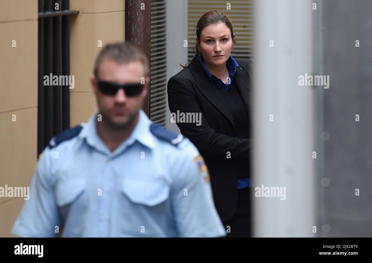 Harriet Wran (right) is escorted to a prison transport vehicle at the NSW Supreme Court in ...