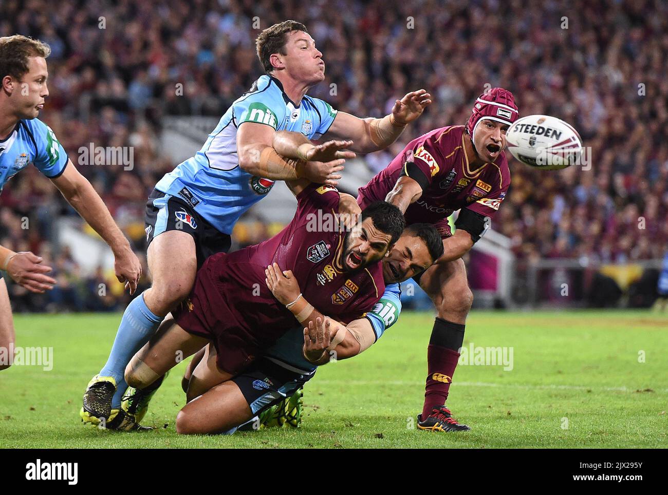 Greg Inglis of the Queensland Maroons (centre) loses the ball in a ...