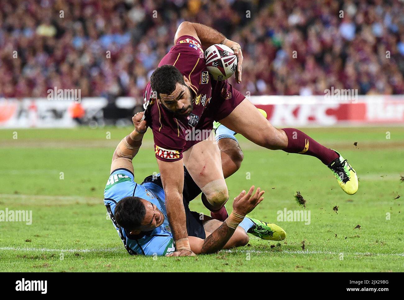 Greg Inglis of the Queensland Maroons (top) is tackled by Dylan Walker ...