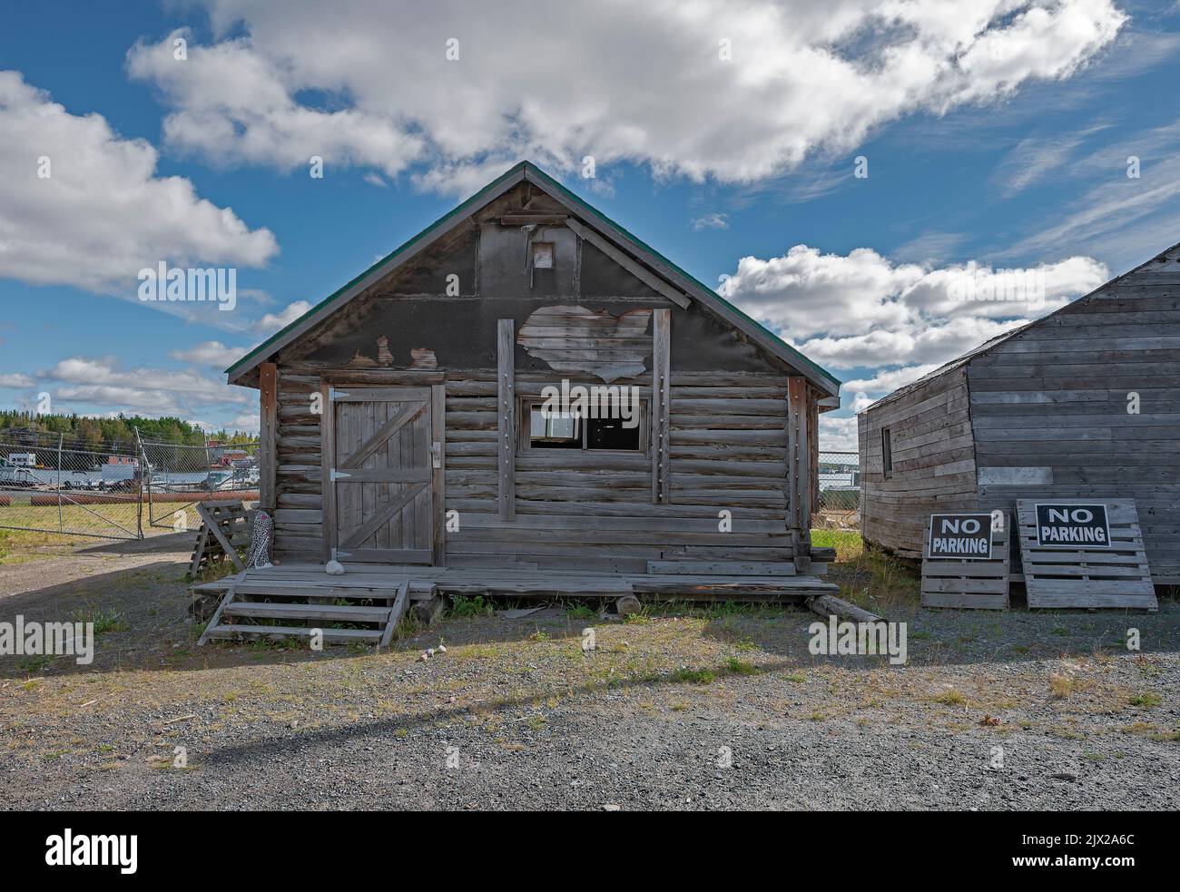 Old log building next to Great Slave Lake in the city of Yellowknife in ...