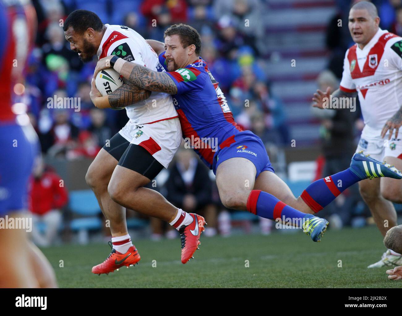 Leeson Ah Mau of the Dragons is tackled by Korbin Sims of the Knights ...