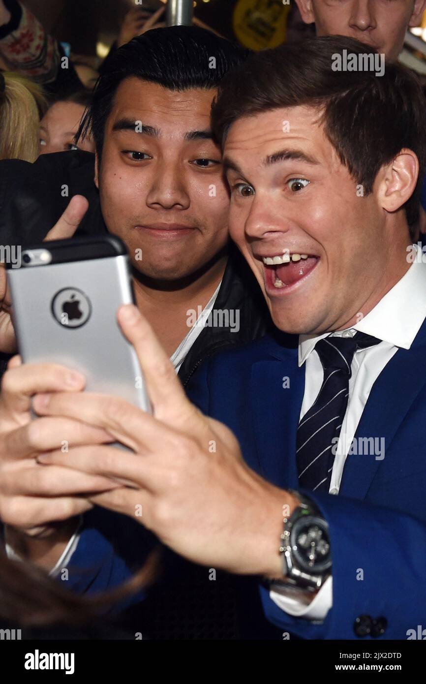 American actor Adam Devine (right) poses for photographs with fans ...