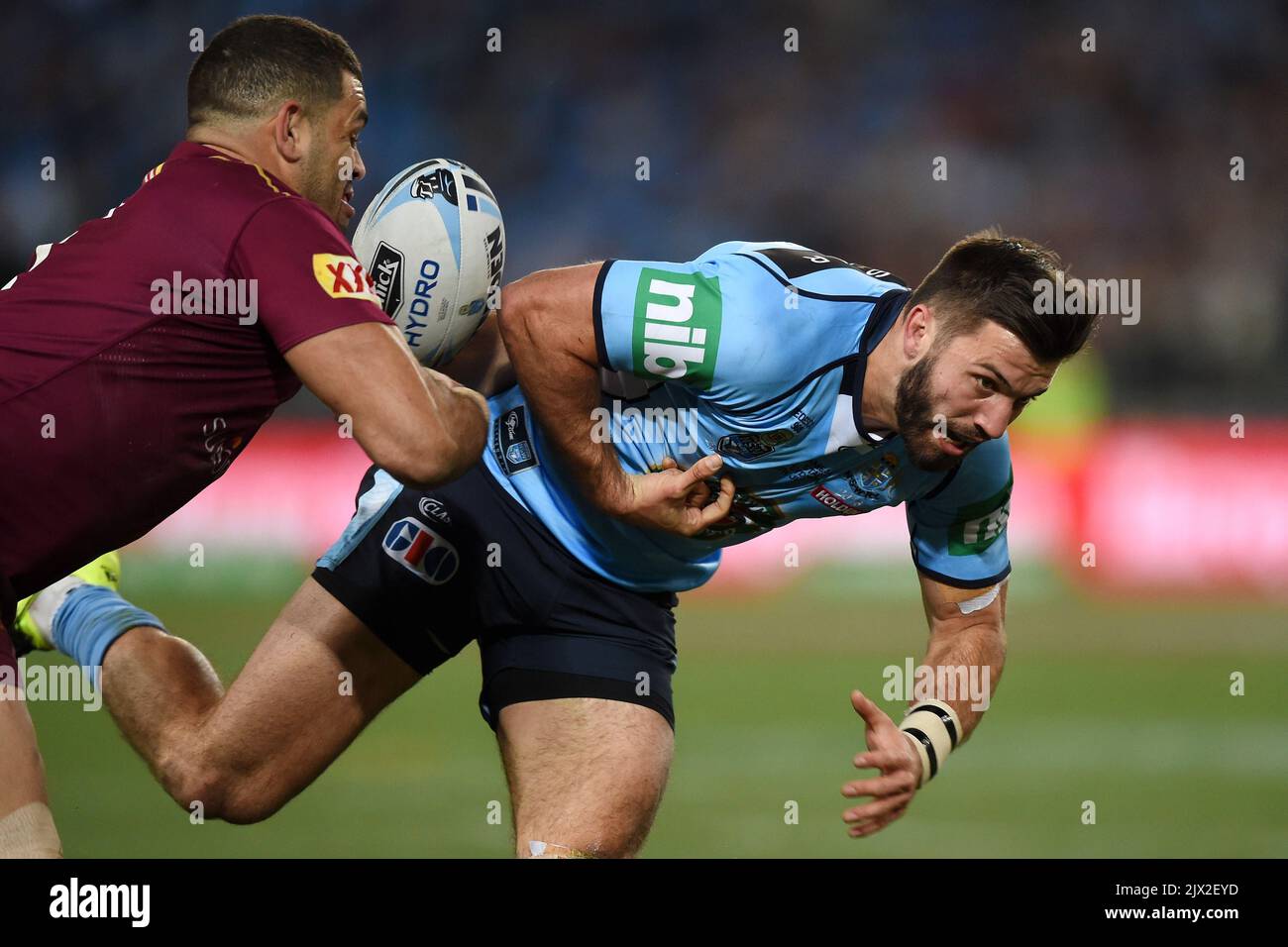 James Tedesco (right) of the Blues has the ball stripped by Greg Inglis ...
