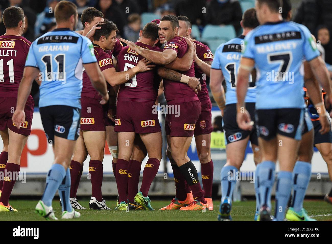 Greg Inglis of the Maroons (centre) celebrates his opening try during ...