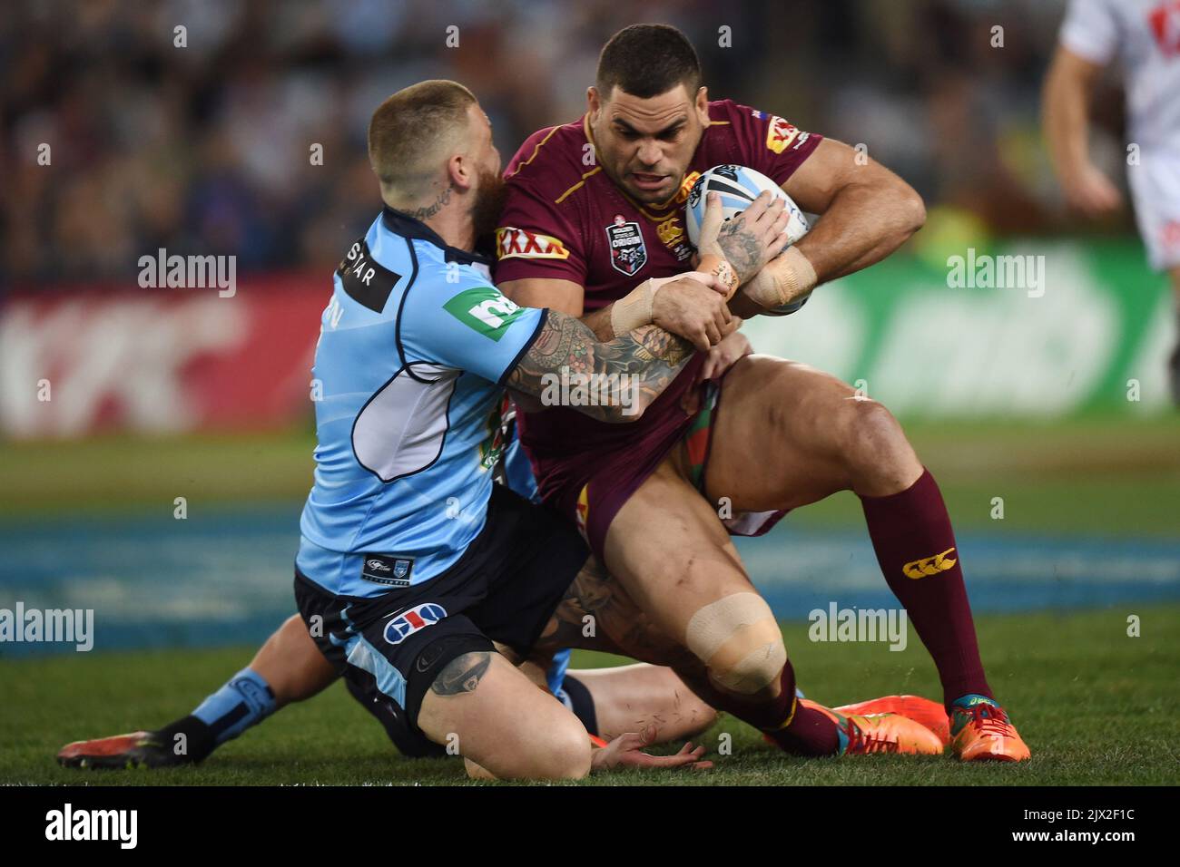 Greg Inglis of the Maroons is tackled by Josh Dugan of the Blues during ...