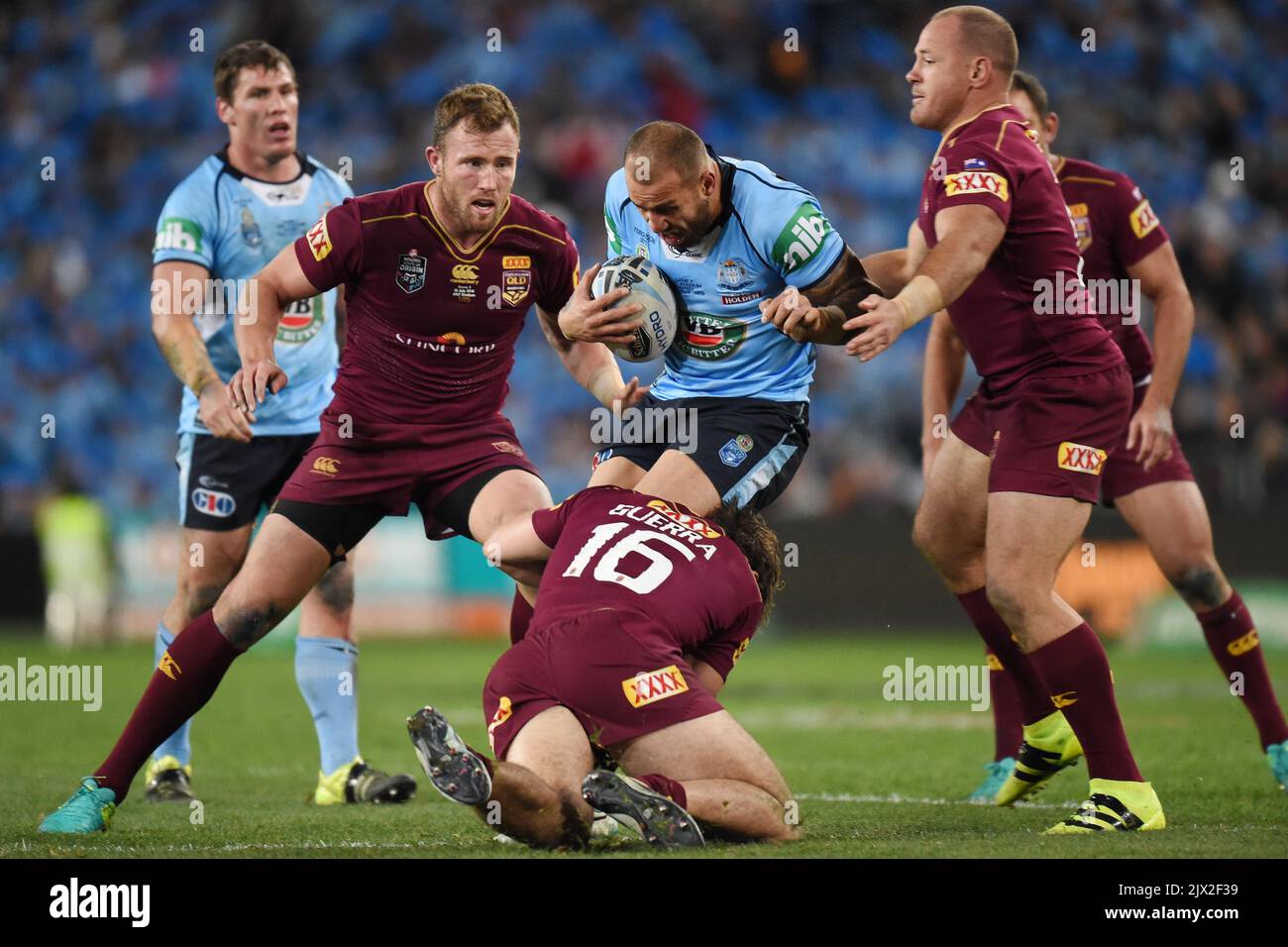 Blake Ferguson of the Blues is tackled by Aiden Guerra of the Maroons ...