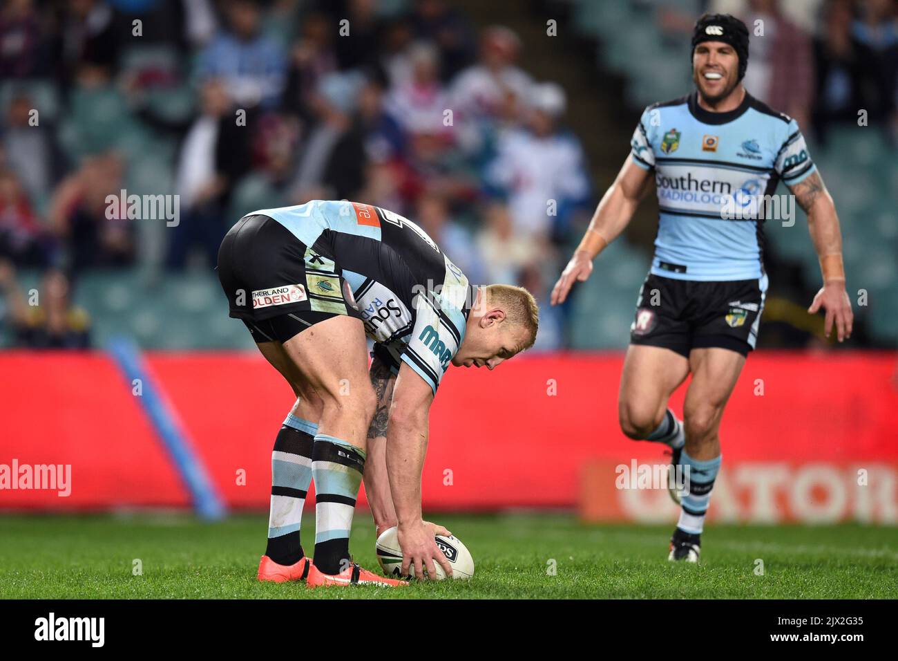 Luke Lewis (left) of the Sharks scores a try during the round 19 NRL ...