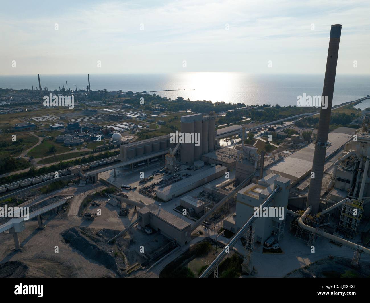 An aerial above a harborfront coal mining and processing facility, seen ...