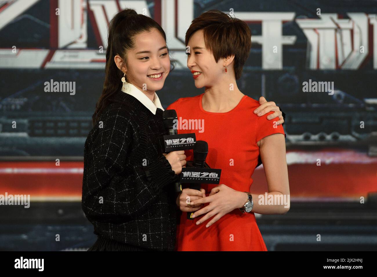 Bleeding Steel actors Nana Ouyang and Erica Xia-Hou embrace during a ...
