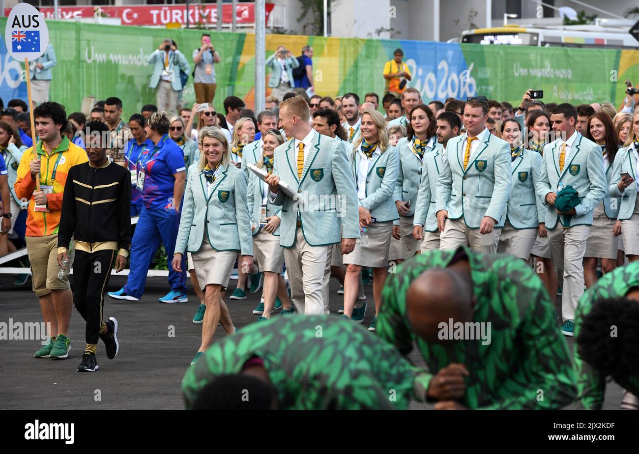 Australian team members are led by Chef de Mission Kitty Chiller during ...