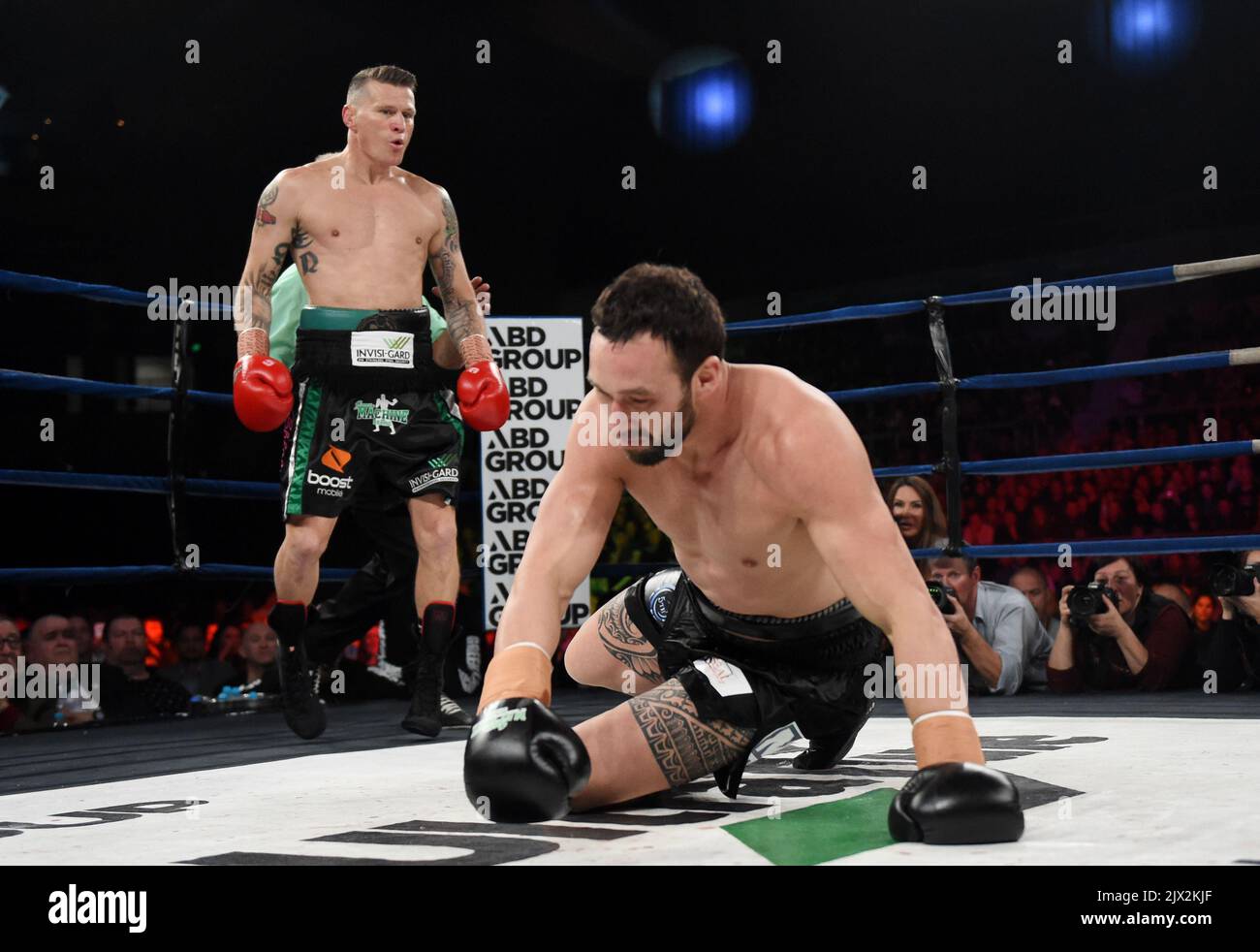 Australian boxer Danny Green knocks down Kane Watts during their bout ...