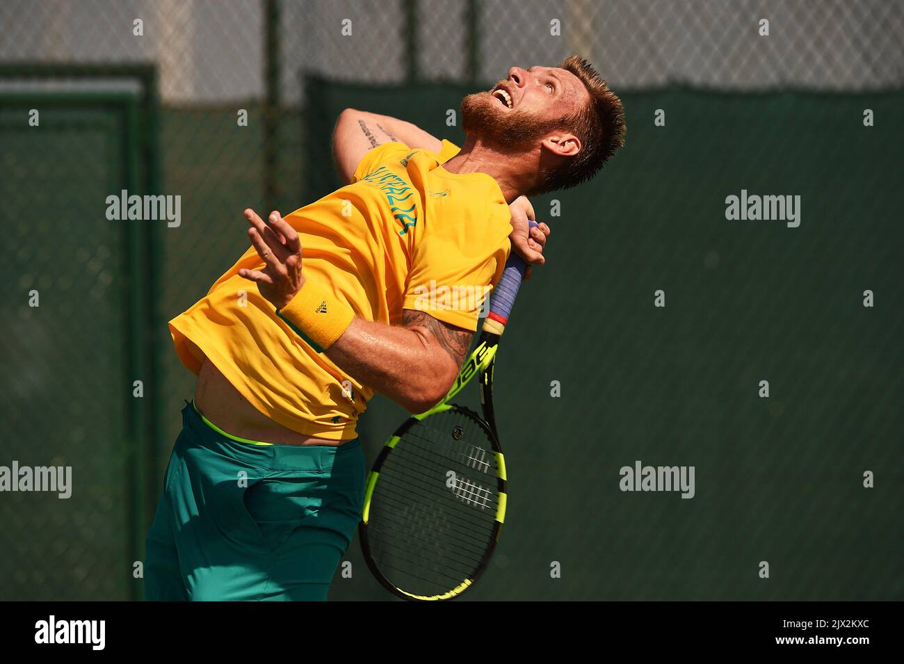 Australian Tennis player Sam Groth hits a serve during tennis practice ...