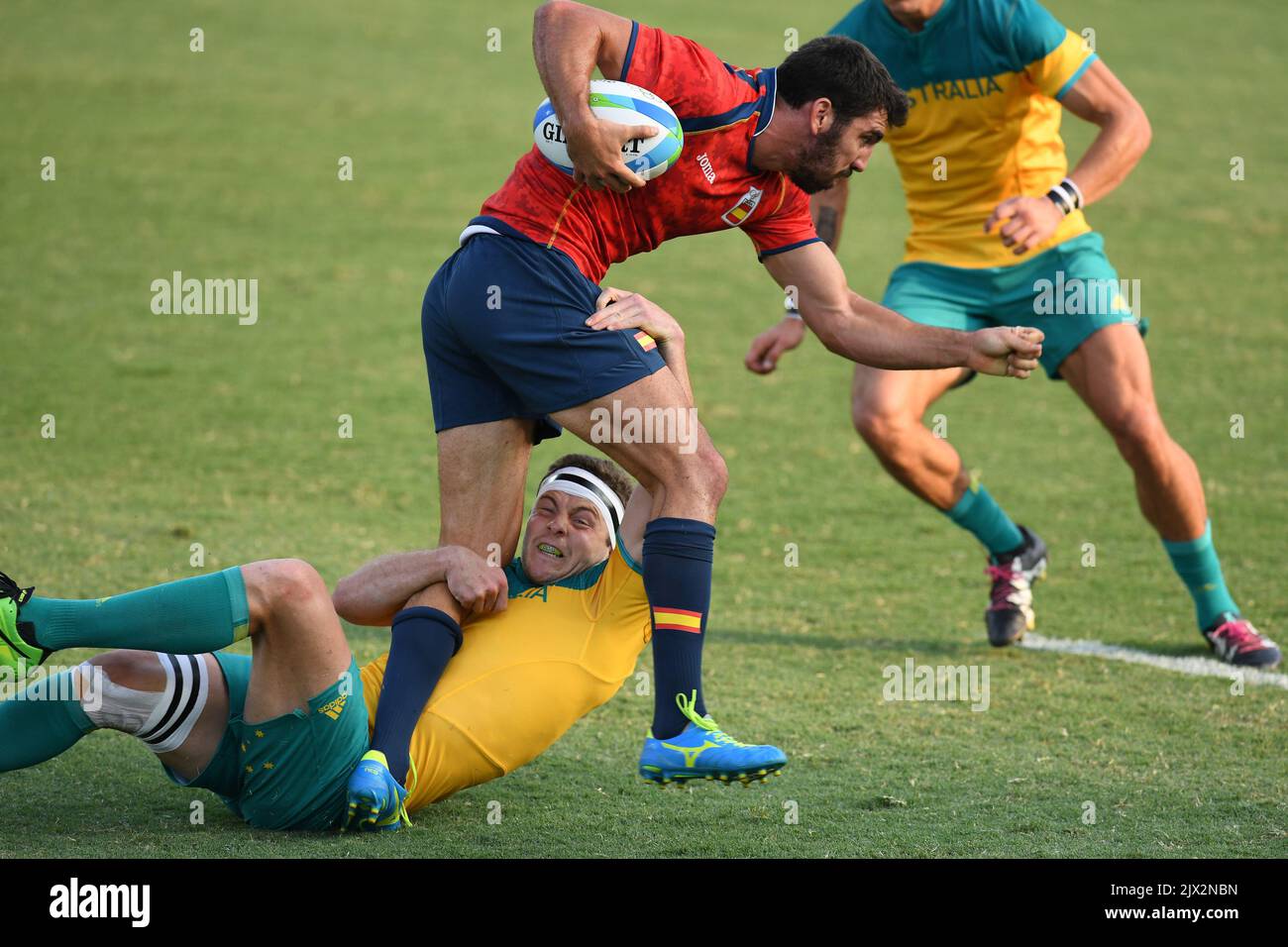 CAPTION CORRECTION. Australia's Nick Malouf and John Porch tackle Spain ...