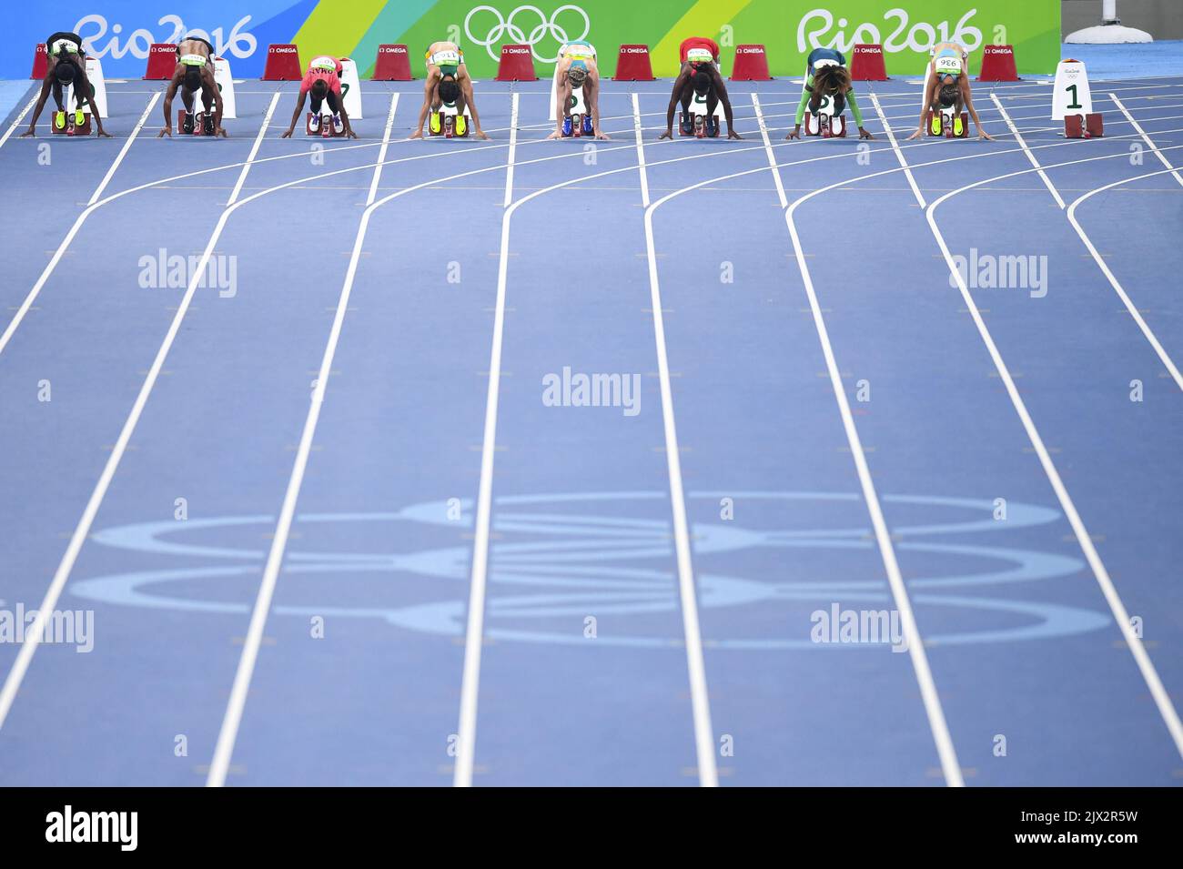 Runners get ready to compete in the Women's 100m Round 1 Heat at ...