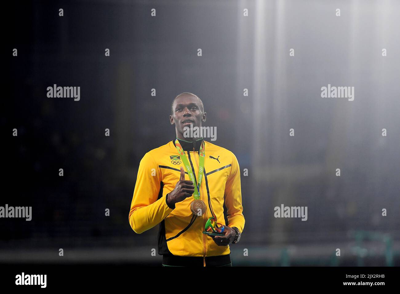 Usain Bolt of Jamaica celebrates receiving his Gold Medal in the Men's ...
