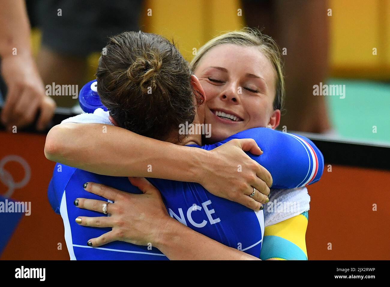 Annette Edmondson of Australia is consoled by Laurie Berthon of France ...