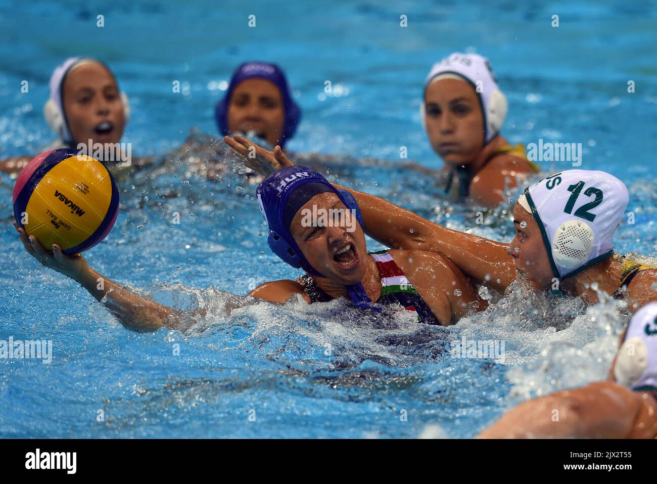 Lea Yanitsas of Australia strikes for possession over Ildiko Toth of ...