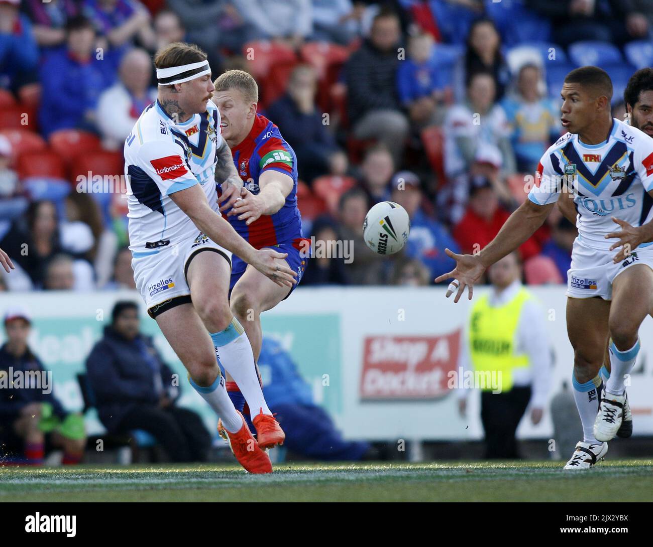 Chris McQueen of the Titans passes the ball to David Mead during the ...