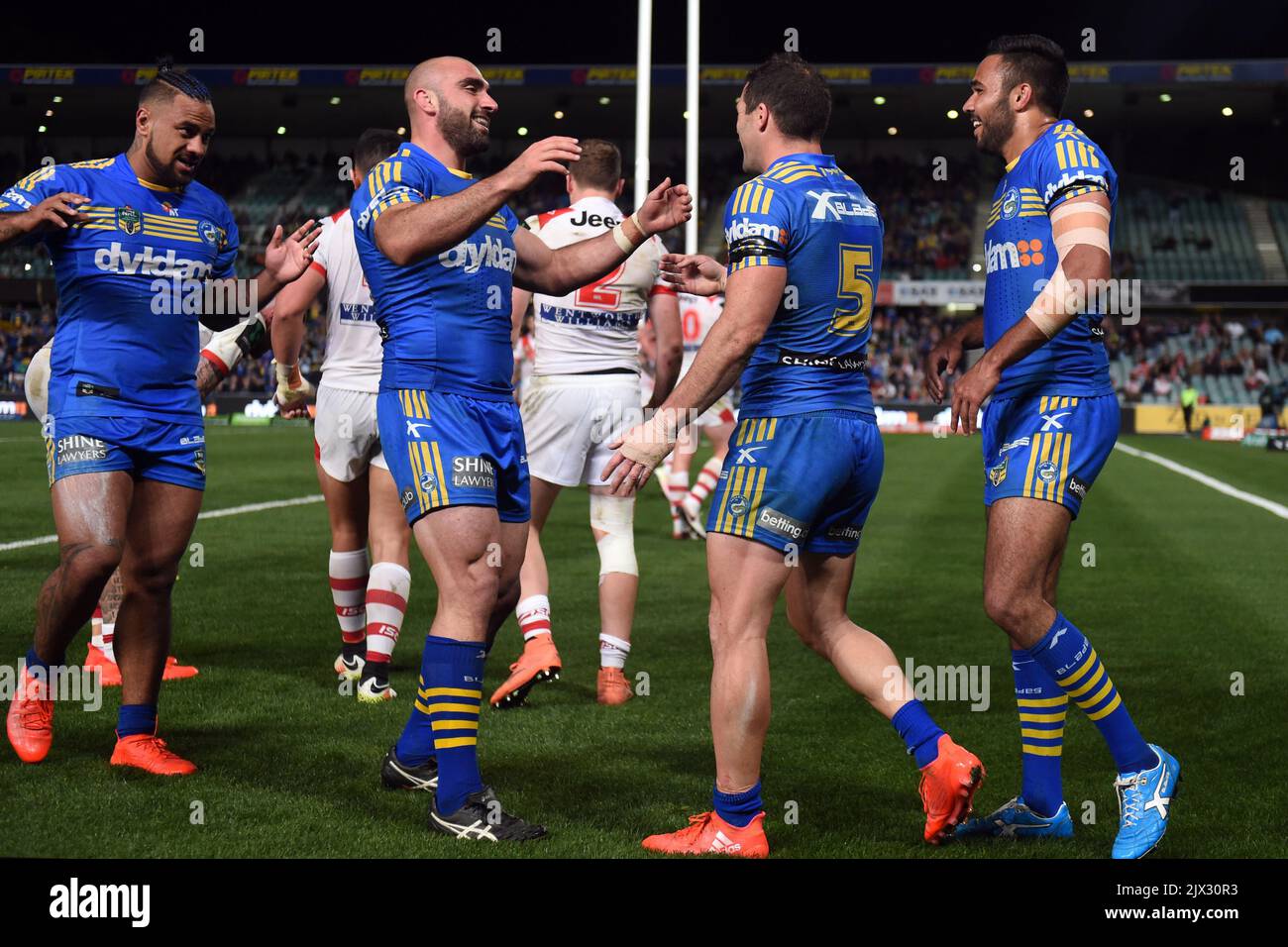 Michael Gordon (2nd right) of the Eels is congratulated after scoring ...
