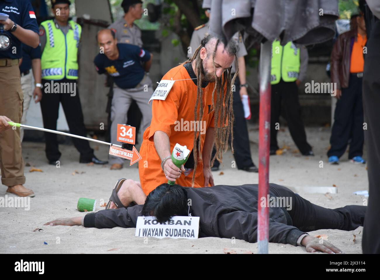 British man David Taylor re-enacts a scene on Kuta beach as a police ...