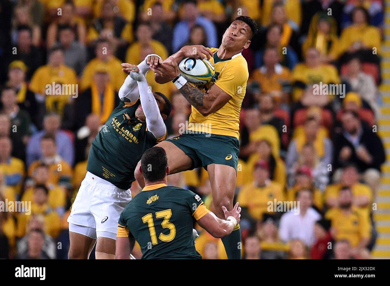 Israel Folau of the Australian Wallabies (right) takes a high ball ...