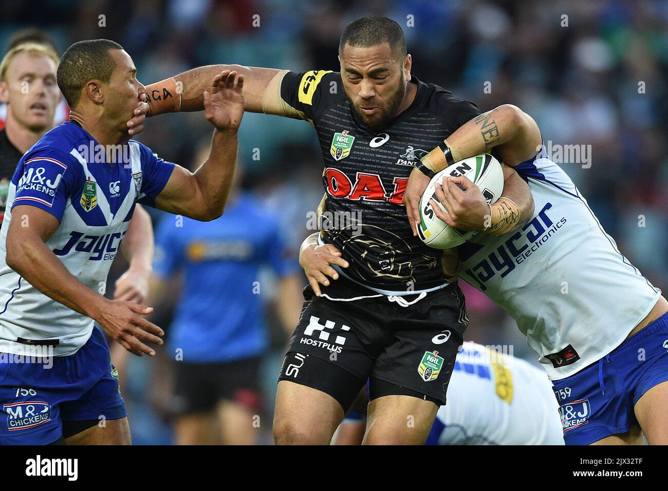 Suaia Matagi of the Panthers is tackled by Moses Mbye, (left), and ...