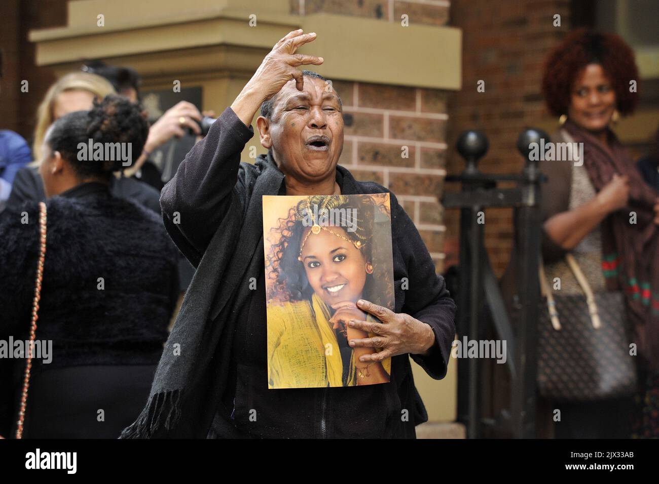 A woman believed to be the mother of Wubanchi Asfaw holding a photo ...