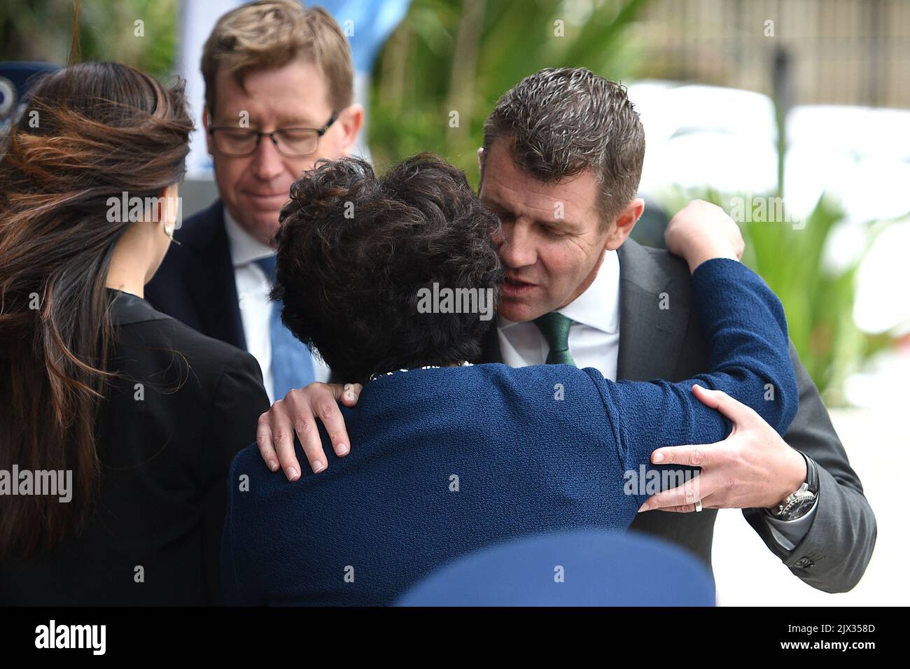 NSW Premier Mike Baird embraces Selina Cheng, the widow of Curtis Cheng ...