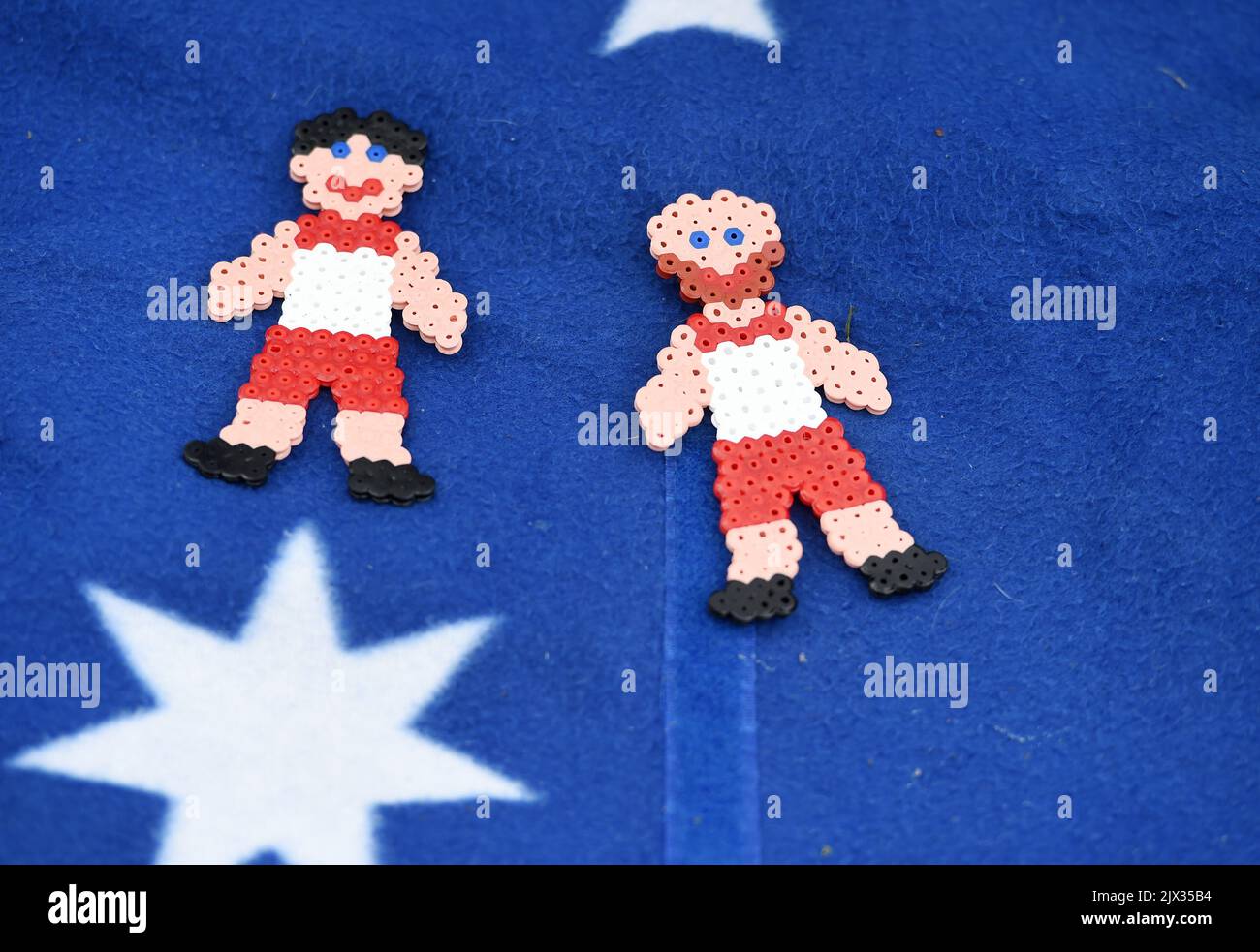 Children sell handmade Bulldogs and Swan player badges at the Western ...