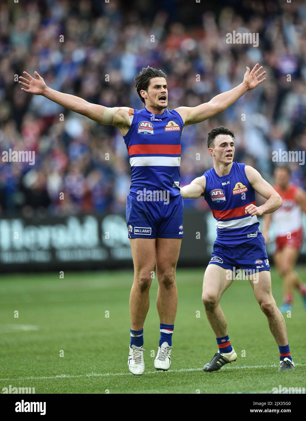 Tom Boyd (left) and Toby McLean of the Western Bulldogs (left) react ...