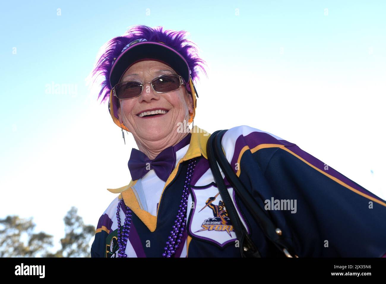 A Melbourne Storm fan poses for a photograph as she arrives for the NRL ...