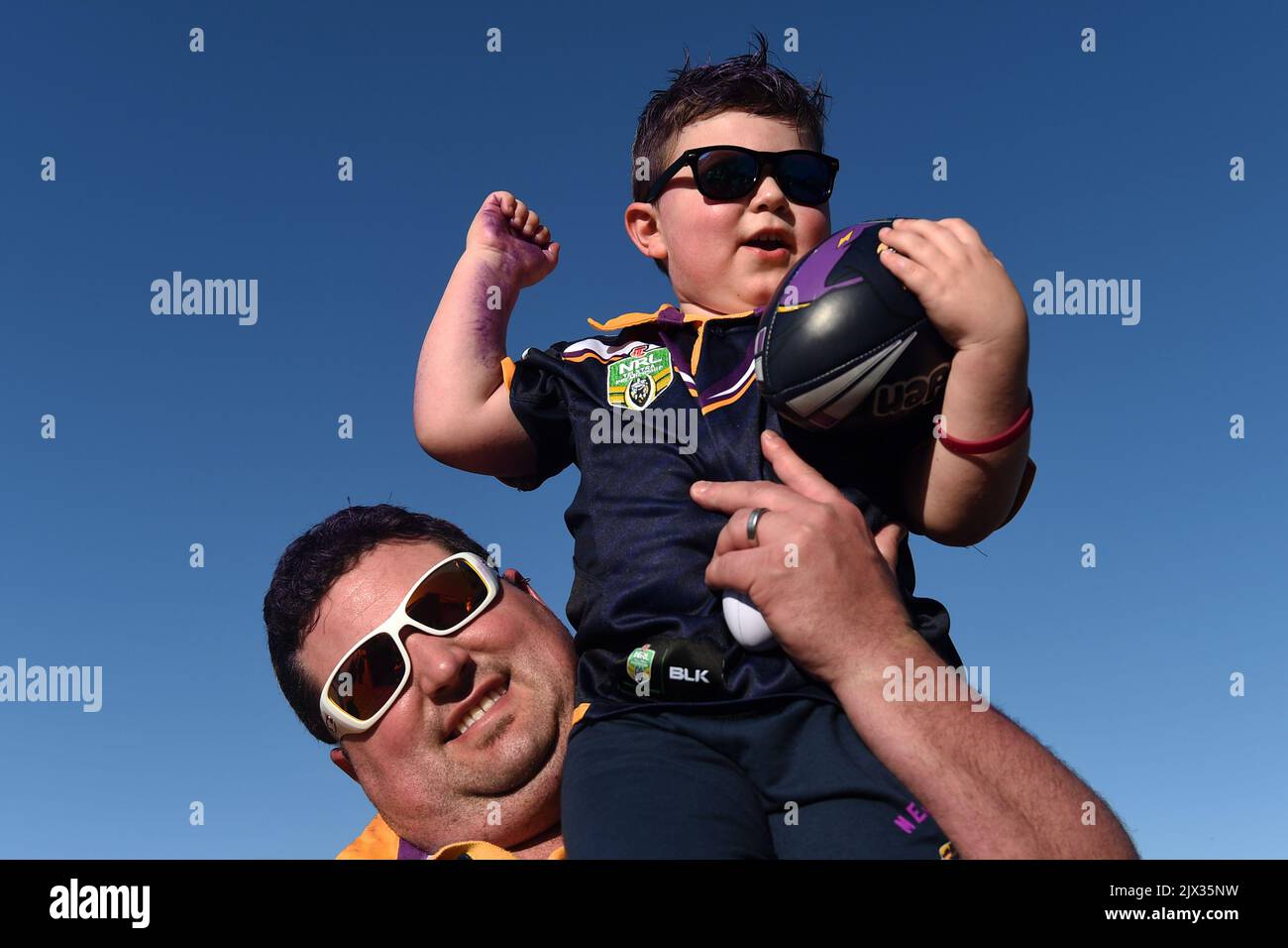 Melbourne Storm fans pose for a photograph as they arrive for the NRL ...