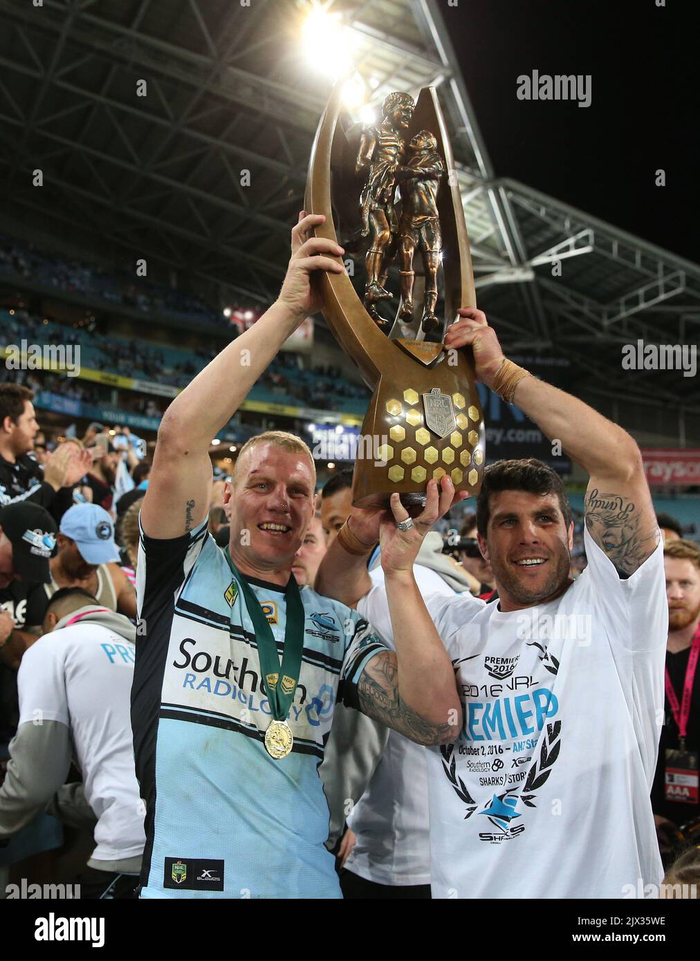 Michael Ennis and Luke Lewis of the Sharks hold the trophy after the ...