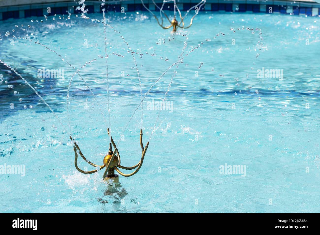 Fountain valve in blue beautiful water on street Stock Photo - Alamy