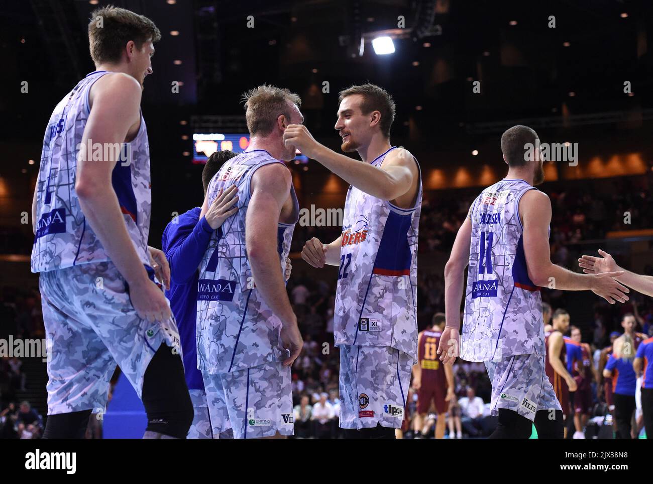 Adelaide 36ers players celebrate defeating the Brisbane Bullets in ...