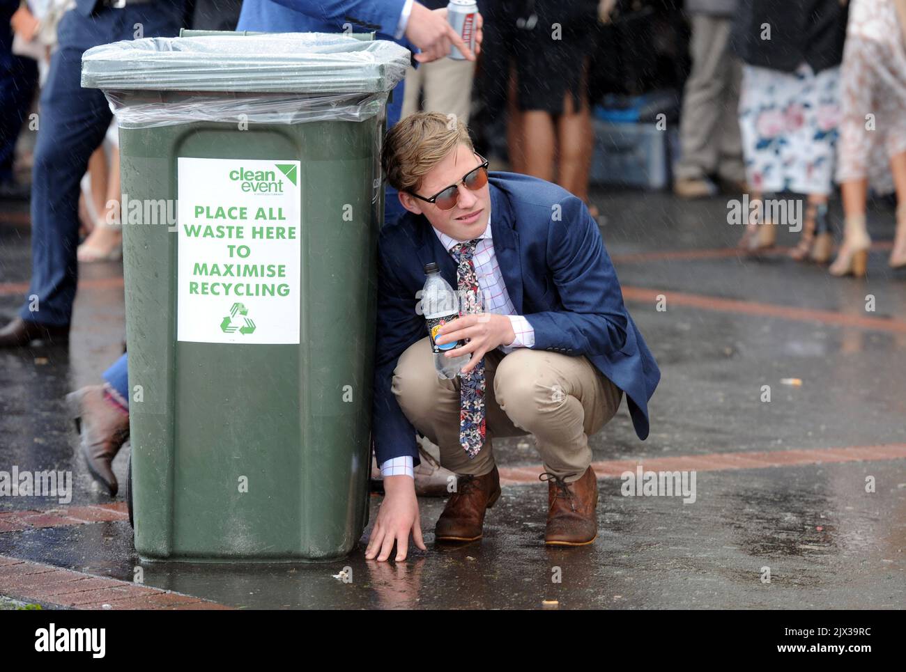 Racegoers take shelter from the rain on Cox Plate Day at Moonee Valley ...