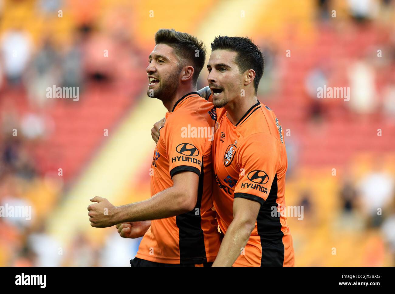 Brandon Borrello of the Brisbane Roar (left) celebrates scoring a goal ...